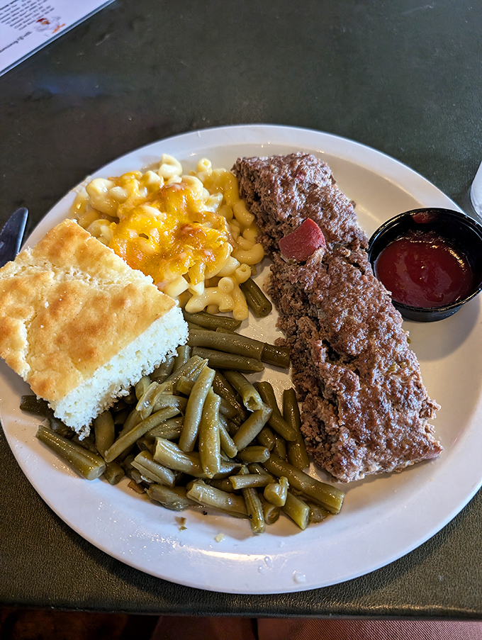 Behold the Monday miracle: meatloaf with mac and cheese, green beans, and cornbread. Grandma would approve, then steal your plate.