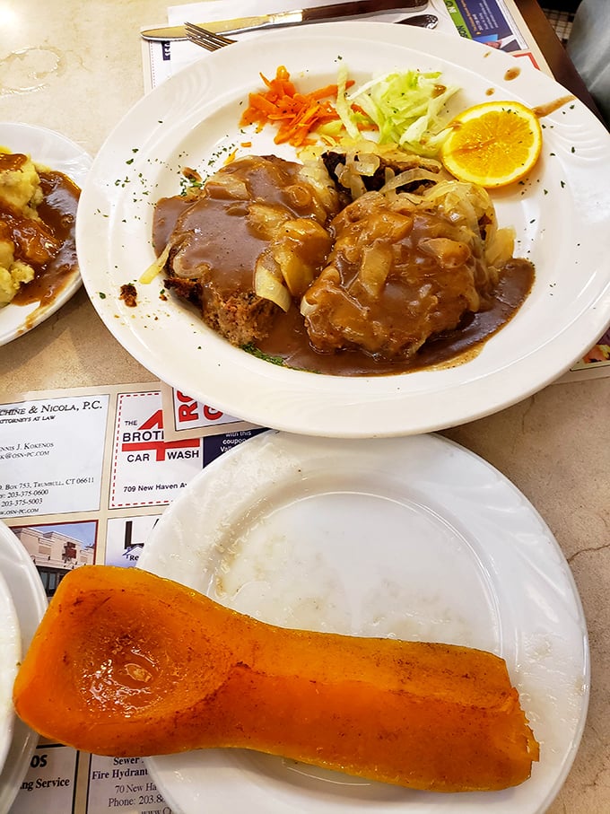 Behold the legendary meatloaf that launches road trips across Connecticut. Perfectly seasoned, draped in rich brown gravy, with colorful vegetables that don't feel like an afterthought.