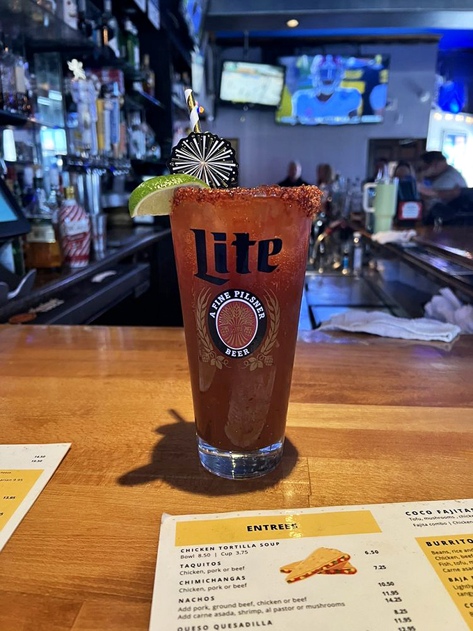 This isn't just a michelada—it's a spicy, savory work of art in a Miller Lite glass that somehow makes Monday feel like Friday.