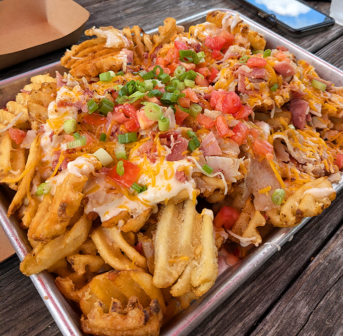 These loaded fries don't just sit on the plate&mdash;they throw a party. Melted cheese, ham, tomatoes, and green onions create a symphony of textures and flavors.