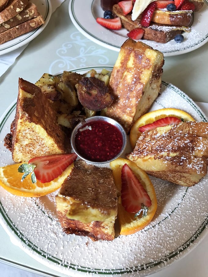 French toast architecture at its finest&mdash;a golden cathedral of carbs. The raspberry compote in the center isn't just a condiment, it's the beating heart.
