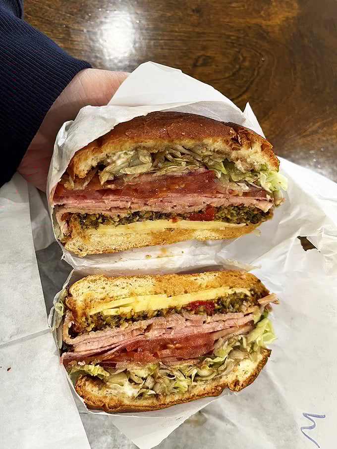This isn't just a sandwich; it's architecture. Layers of Italian meats, cheese, and that magical olive spread create the skyscraper of sandwiches worth driving hours for.