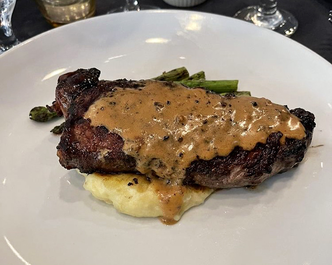 This NY Strip isn't just dinner&mdash;it's a masterclass in steak preparation, complete with a peppercorn sauce that could make you forget your own name.