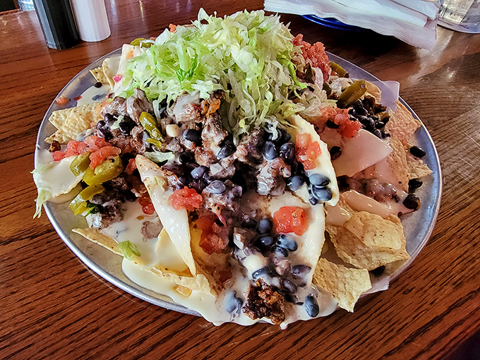 Not so much a plate of nachos as a mountain range of flavor, with valleys of cheese and peaks of fresh toppings.