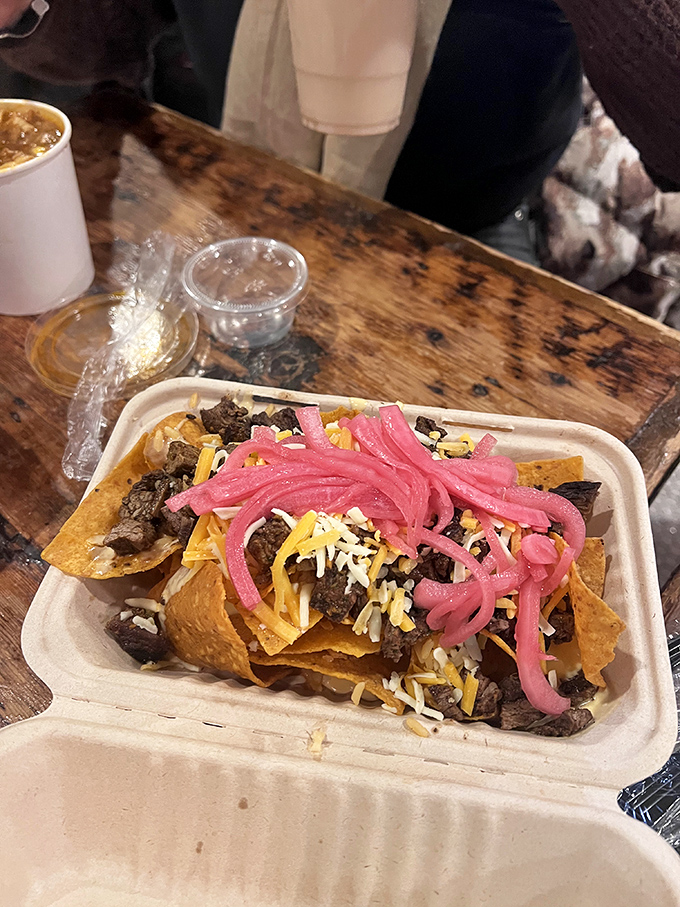 These nachos aren't just a snack&mdash;they're an architectural masterpiece of beef, cheese, and those glorious pickled red onions that make everything better.