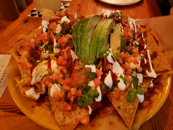 Not your college dorm nachos! These beautifully constructed layers of crispy chips, fresh toppings, and that perfect avocado crown deserve their own Instagram account.