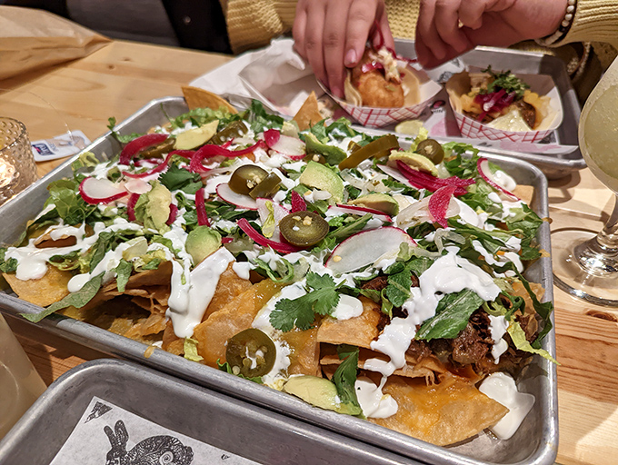 These aren't your average ballpark nachos. Vibrant jalape&ntilde;os, pickled radishes, and creamy drizzles transform tortilla chips into an edible work of art.