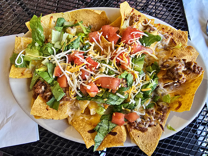 These nachos aren't just a dish—they're an architectural marvel of crispy chips, melted cheese, and fresh toppings that would make Frank Lloyd Wright jealous.