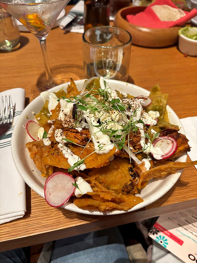 These aren't your average ballpark nachos. Topped with crema, radishes, and microgreens, they're dressed better than most people at a New Jersey wedding.