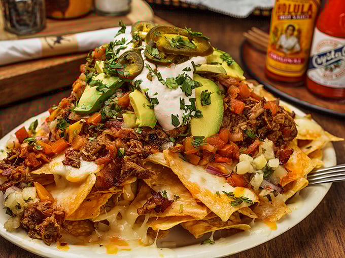 These nachos don't just have toppings&mdash;they have architecture. Every layer tells a story, with avocado slices standing like green sentinels guarding flavor treasure.