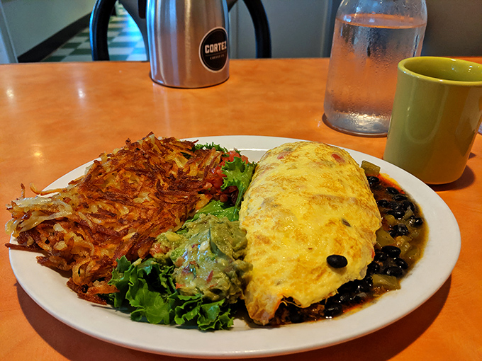 Golden-yellow omelet meets crispy hash browns in a plate romance that would make any breakfast lover swoon with delight.