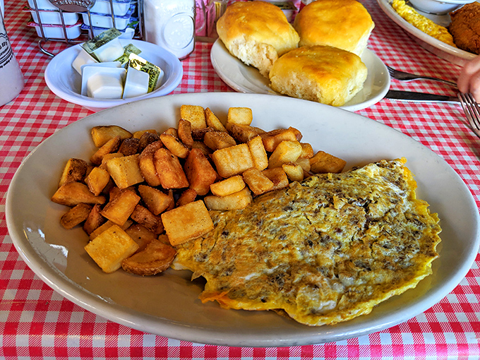 An omelet that's had a meaningful relationship with cheese, nestled beside home fries that could make a potato farmer weep with pride.