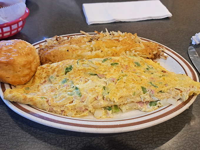 This omelet doesn't just sit on the plate&mdash;it lounges confidently beside golden hash browns like it knows it's the star of the morning show.