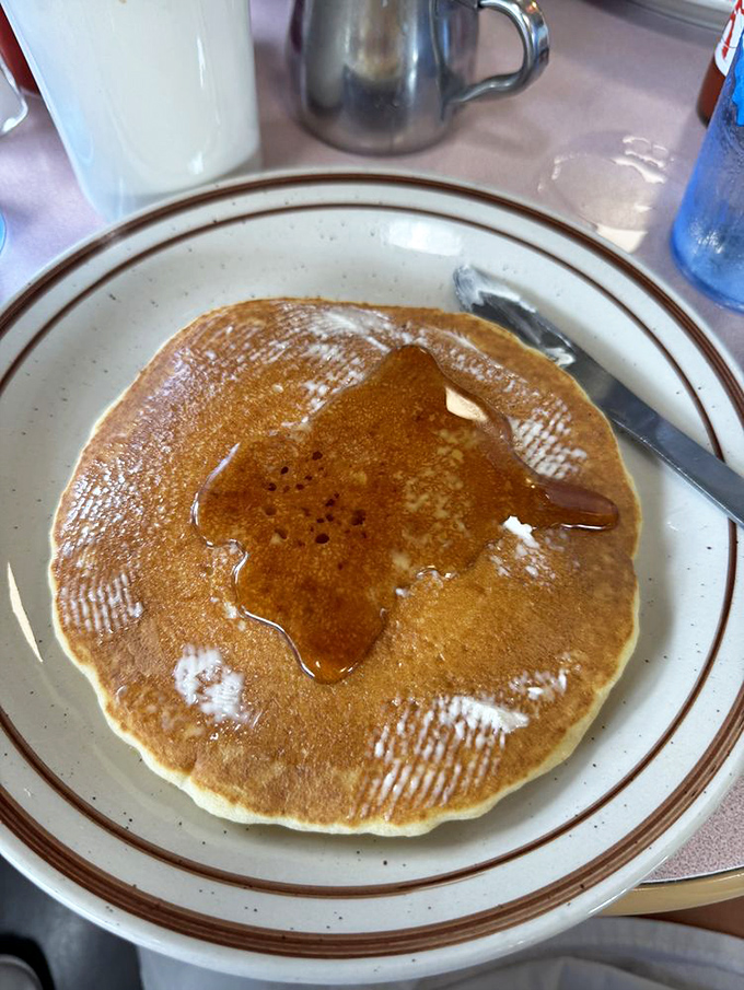 Golden-brown perfection with maple syrup creating tiny amber pools. This isn't just breakfast; it's edible sunshine on a plate.