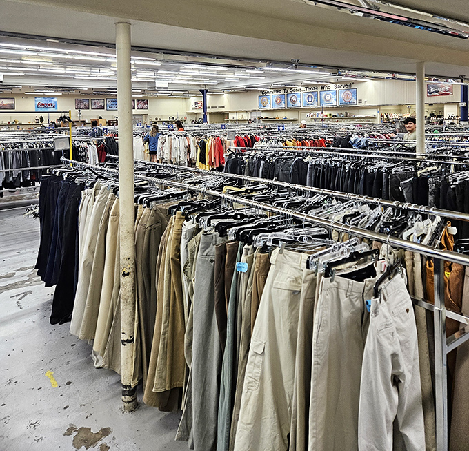 Khakis and slacks hang with military precision, a neutral-toned sea of possibilities for anyone needing to look presentable without the department store sticker shock.