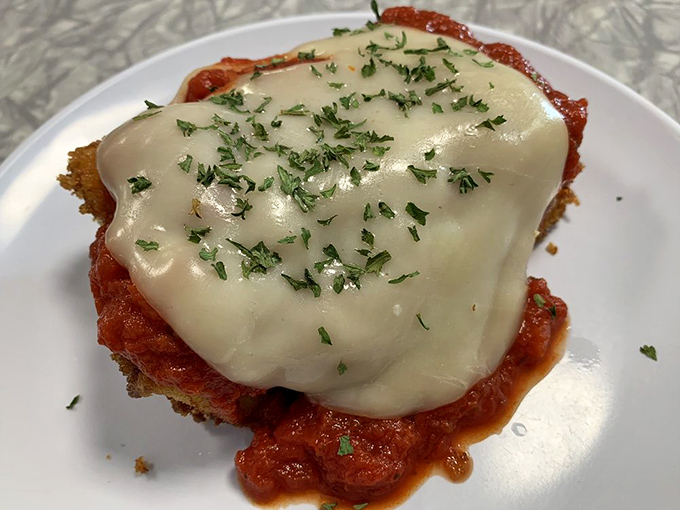 This isn't just melted cheese on chicken parmesan; it's a hug on a plate, complete with fresh herbs that say "someone in this kitchen cares."