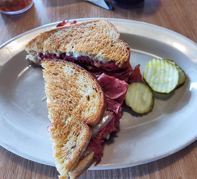 This pastrami sandwich isn't just lunch&mdash;it's a religious experience. The perfectly toasted rye, the heap of meat, those pickles standing guard. Perfection.