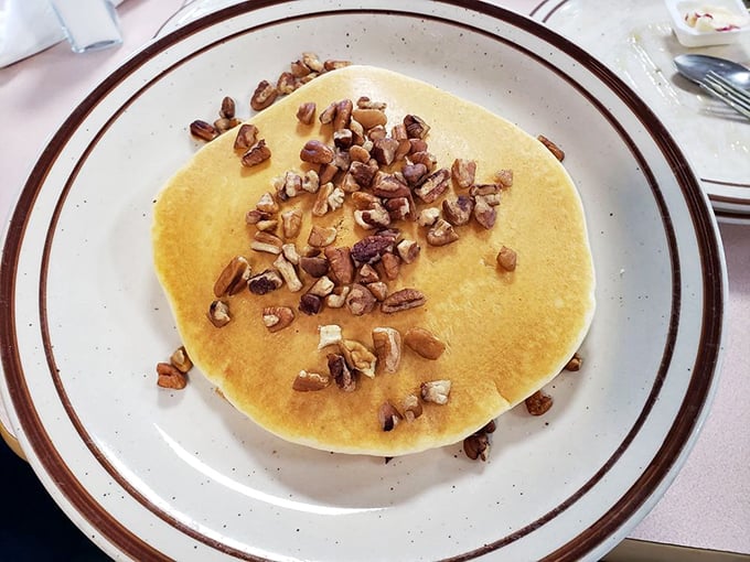 A golden pancake crowned with crunchy pecans&mdash;proof that sometimes the simplest pleasures are the most profound.