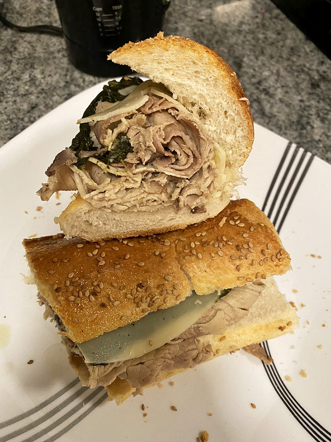 Behold the holy trinity of pork, provolone, and greens&mdash;architectural perfection where each layer plays its crucial role in sandwich symphony.