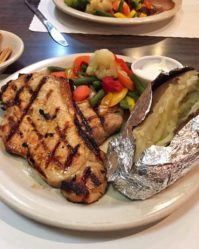 Perfectly grilled protein paired with vibrant vegetables and a foil-wrapped potato &ndash; proof that The Country Way's culinary skills extend well beyond breakfast hours.