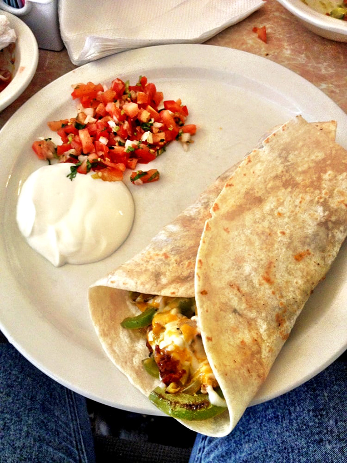 This porter burrito isn't just food; it's edible architecture. The perfect ratio of meat to cheese, with fresh pico and sour cream standing by.