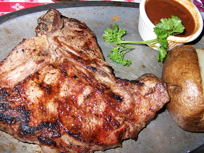 Enjoy a legendary, flame-grilled porterhouse steak at Trabuco Oaks Steakhouse, perfectly paired with a baked potato and their signature sauce.