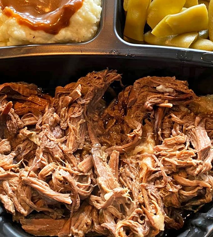 Tender pot roast that practically surrenders to your fork, swimming alongside creamy mashed potatoes and yellow squash. Comfort food's greatest hits on one plate.