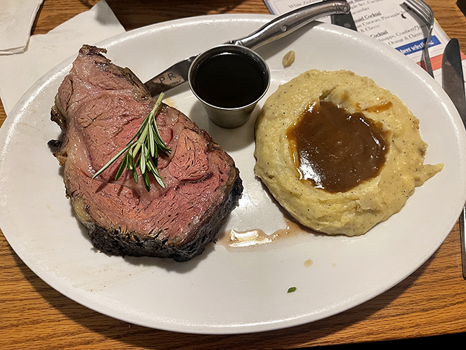 Behold the star of the show: prime rib cooked to that perfect shade of pink, accompanied by garlic mashed potatoes that could make a potato proud.