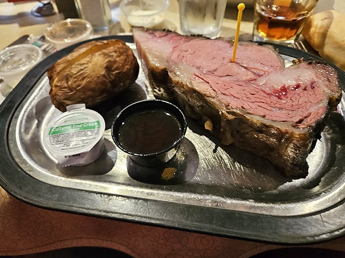 Behold the star of the show: prime rib so perfectly pink it should have its own Instagram account, accompanied by a potato that could feed a small village. 