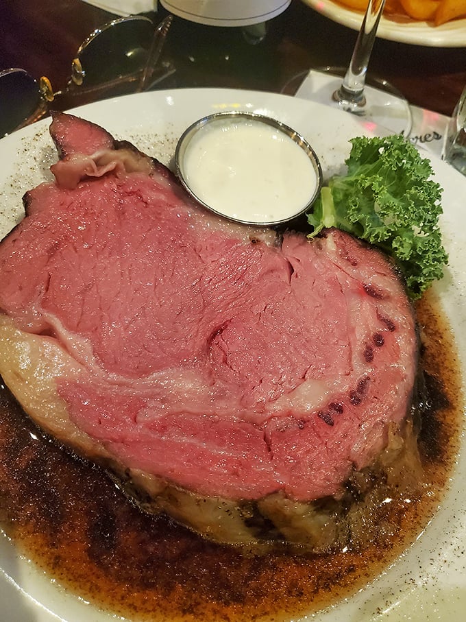The prime rib arrives like a rosy revelation, swimming in its natural juices. This is why cavemen discovered fire.