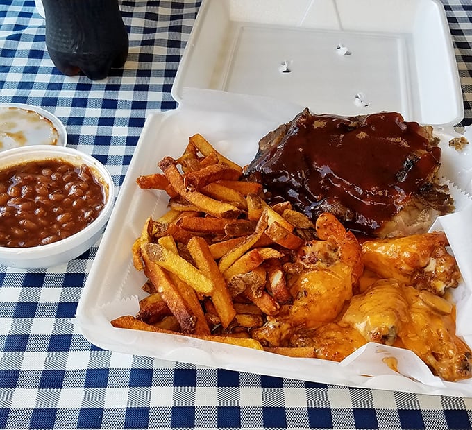 Meat trinity perfection: saucy ribs, golden fries, and wings that could make buffalo jealous. The baked beans are practically mandatory.