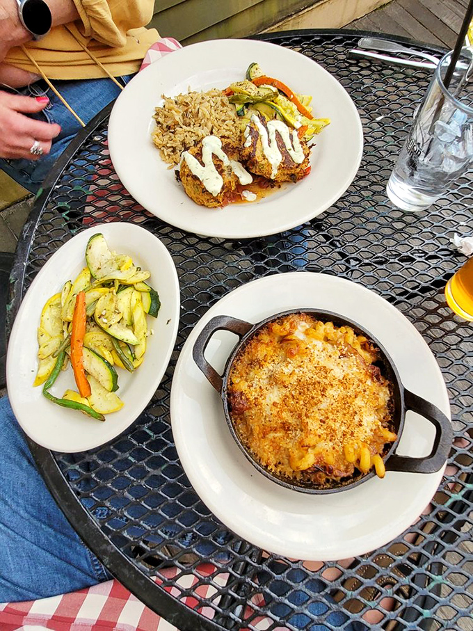 Outdoor dining perfection! That bubbling skillet of mac and cheese is performing a siren song that would make Odysseus snap his own mast in half.