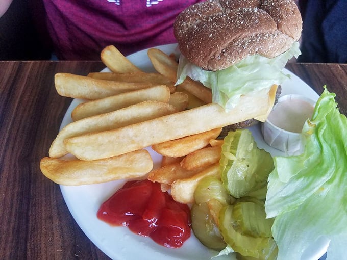 Behold the burger in its natural habitat&mdash;surrounded by crispy fries and the promise that sometimes the simplest pleasures are the most satisfying.