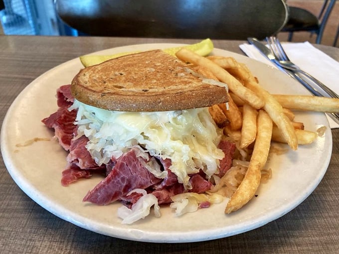Behold the Reuben in all its glory! Corned beef and sauerkraut spill rebelliously from grilled rye bread, a delicious protest against sensible portion sizes.
