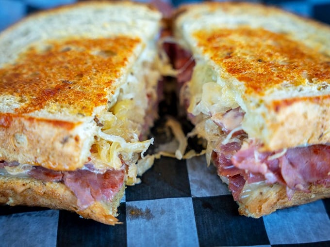 The Reuben in all its glory—where corned beef, sauerkraut, and Swiss cheese perform a perfect harmony that would make Mozart jealous.