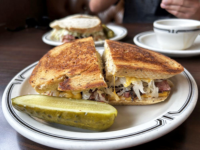 Behold sandwich architecture at its finest! Golden-toasted rye cradles the perfect balance of meat, cheese, and slaw&mdash;a masterpiece that makes other sandwiches question their life choices.