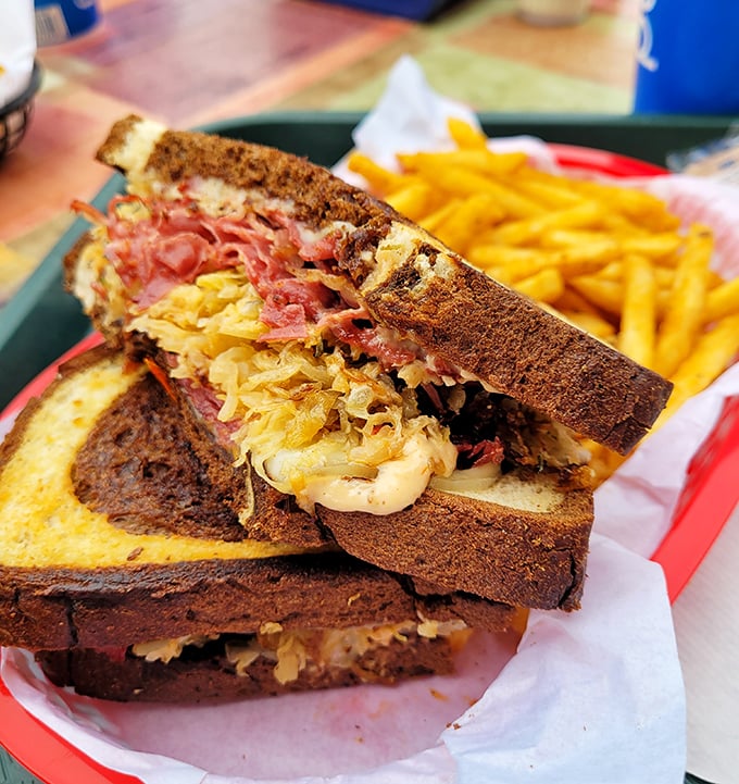 Behold the Reuben in its natural habitat&mdash;perfectly grilled rye, sauerkraut peeking out like it's playing hide-and-seek with that gloriously melted Swiss.