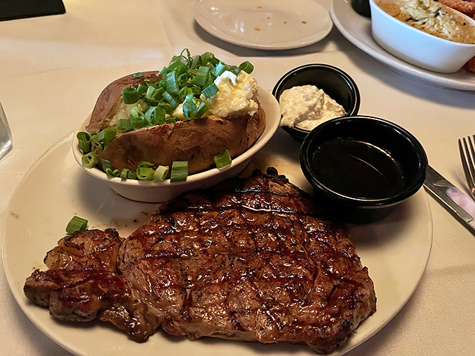 A masterclass in simplicity: perfectly grilled ribeye with a baked potato that's practically begging to be devoured. Steak night perfection!