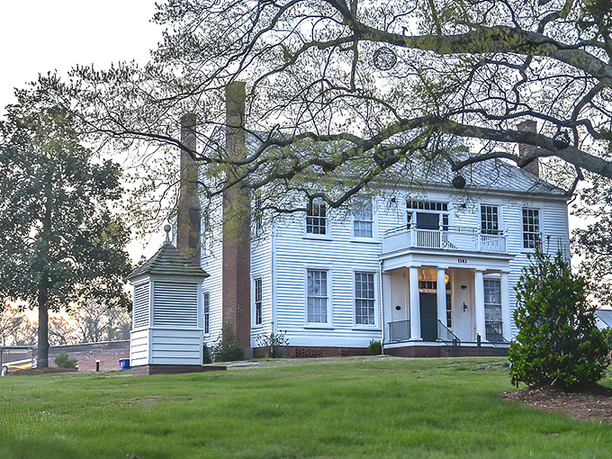 This stately white historic home speaks to Rocky Mount's rich past, with its graceful columns and chimneys standing tall against Carolina blue skies.