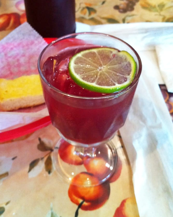 Ruby red sangria garnished with lime—Florida's liquid sunshine in a glass. One sip and you'll understand why people cancel afternoon plans without regret.