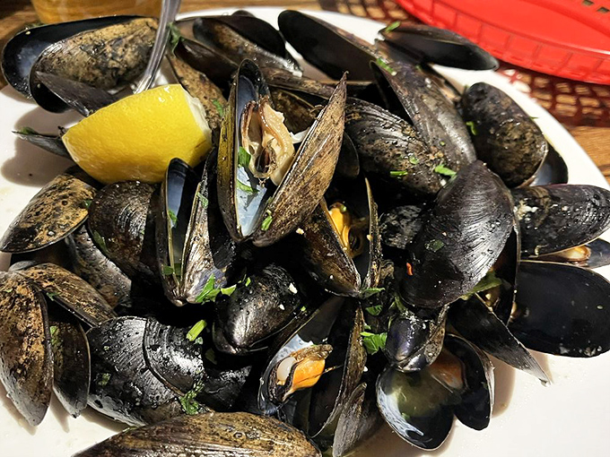 These glistening mussels aren't just dinner&mdash;they're an oceanic symphony, each shell opening to reveal a briny treasure enhanced by fresh herbs and lemon.