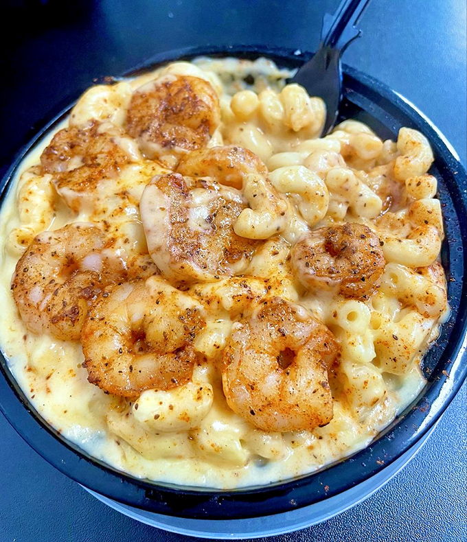 Plump, perfectly seasoned shrimp nestled in a sea of creamy mac and cheese&mdash;a combination that makes seafood skeptics reconsider their life choices.