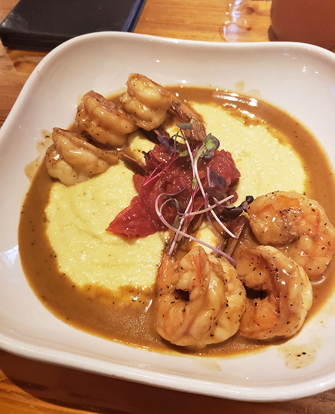 Shrimp and grits that would make a Louisianan weep with joy – plump crustaceans circling a golden island of creamy cornmeal perfection.