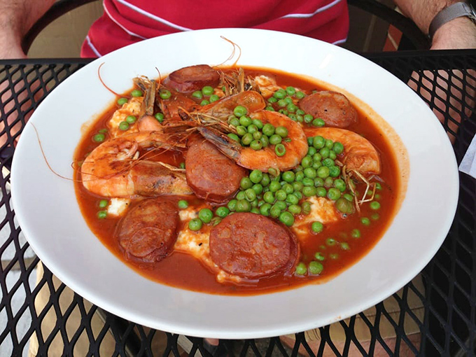 This isn't just shrimp and grits&mdash;it's a Southern hug in a bowl. Plump shrimp and spicy sausage swimming in tomato broth with bright green peas for color.