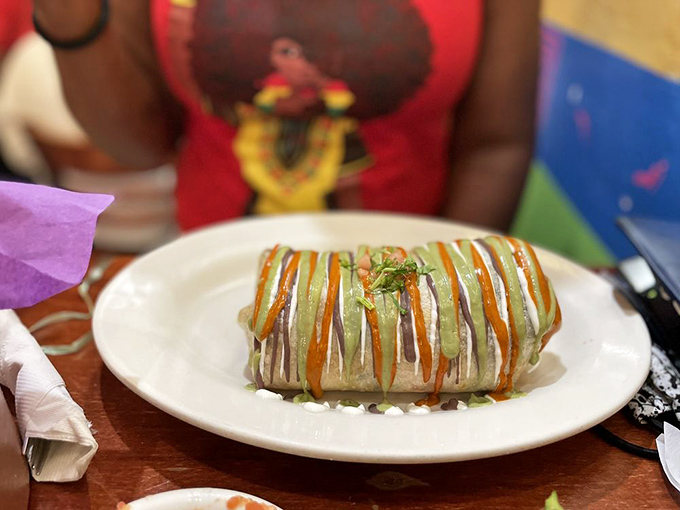 This isn't just a burrito; it's edible artwork. The sauce drizzles create a Jackson Pollock masterpiece you can actually eat without going broke.
