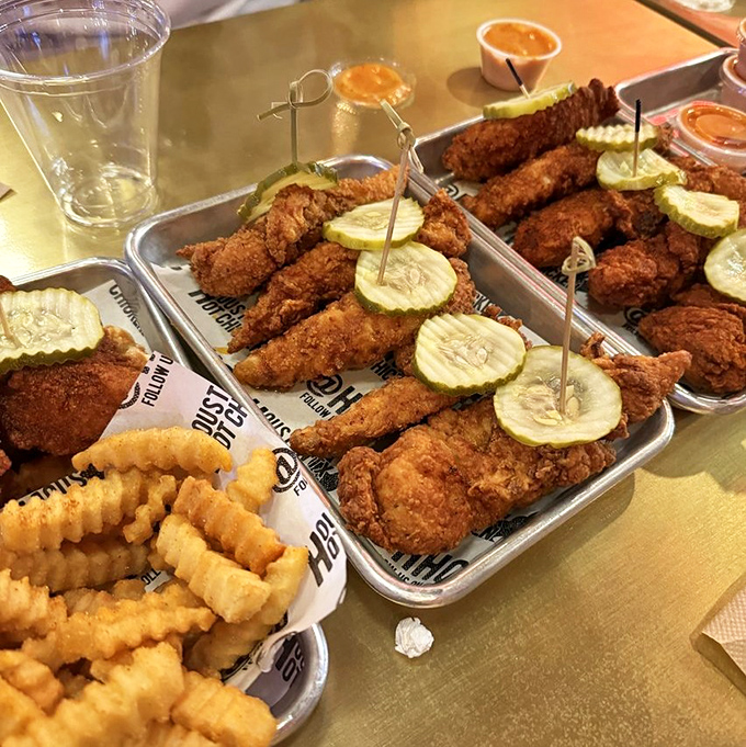 Golden-brown tenders with pickle coins standing guard like spicy sentinels. The crunch you hear? That's the sound of perfection.
