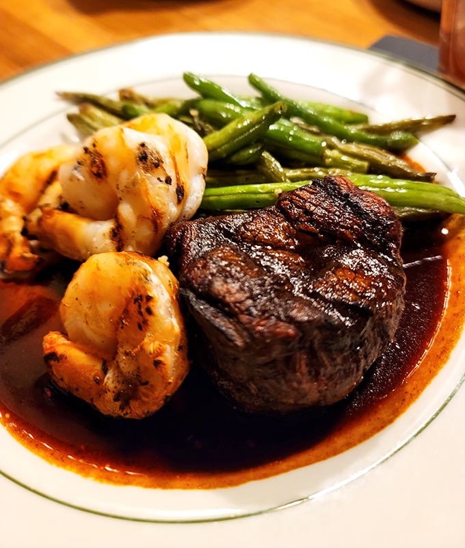 Surf meets turf perfection: a masterfully seared filet mignon shares the spotlight with plump shrimp and crisp asparagus.