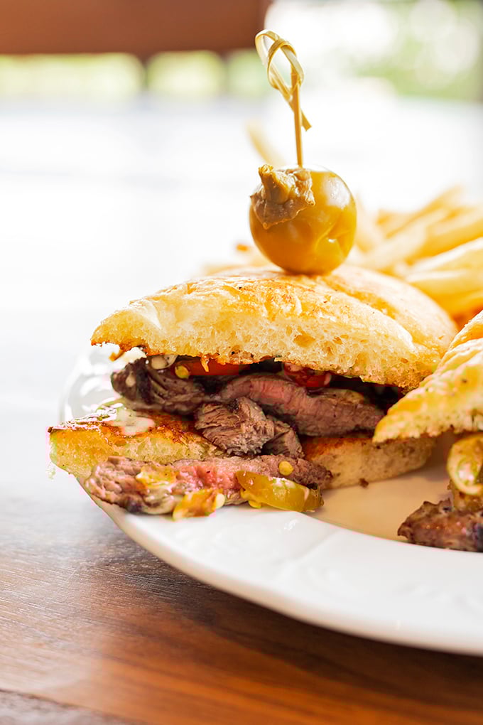 The legendary steak sandwich in all its glory&mdash;tender meat, sweet peppers, and b&eacute;arnaise sauce creating a holy trinity of flavor worth crossing state lines for.