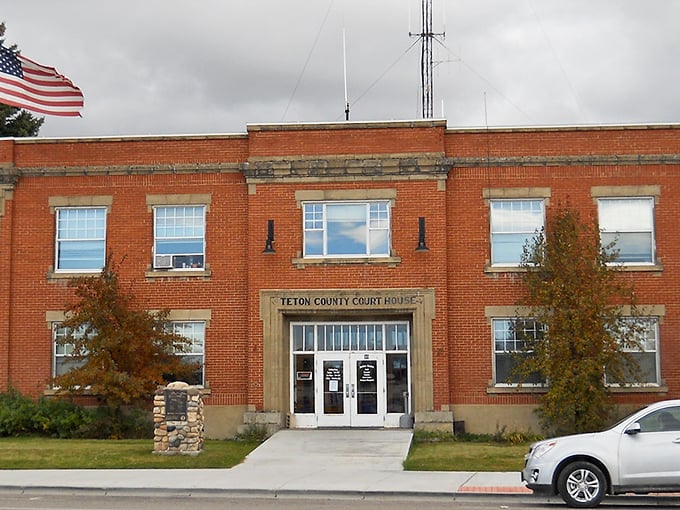 The Teton County Courthouse stands as a brick-and-mortar testament to Driggs' history, its American flag snapping crisply in the mountain breeze.