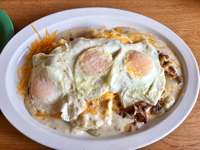 Three sunny-side up eggs crown this mountain of hearty goodness, creating the kind of breakfast that fuels both body and soul for hours.